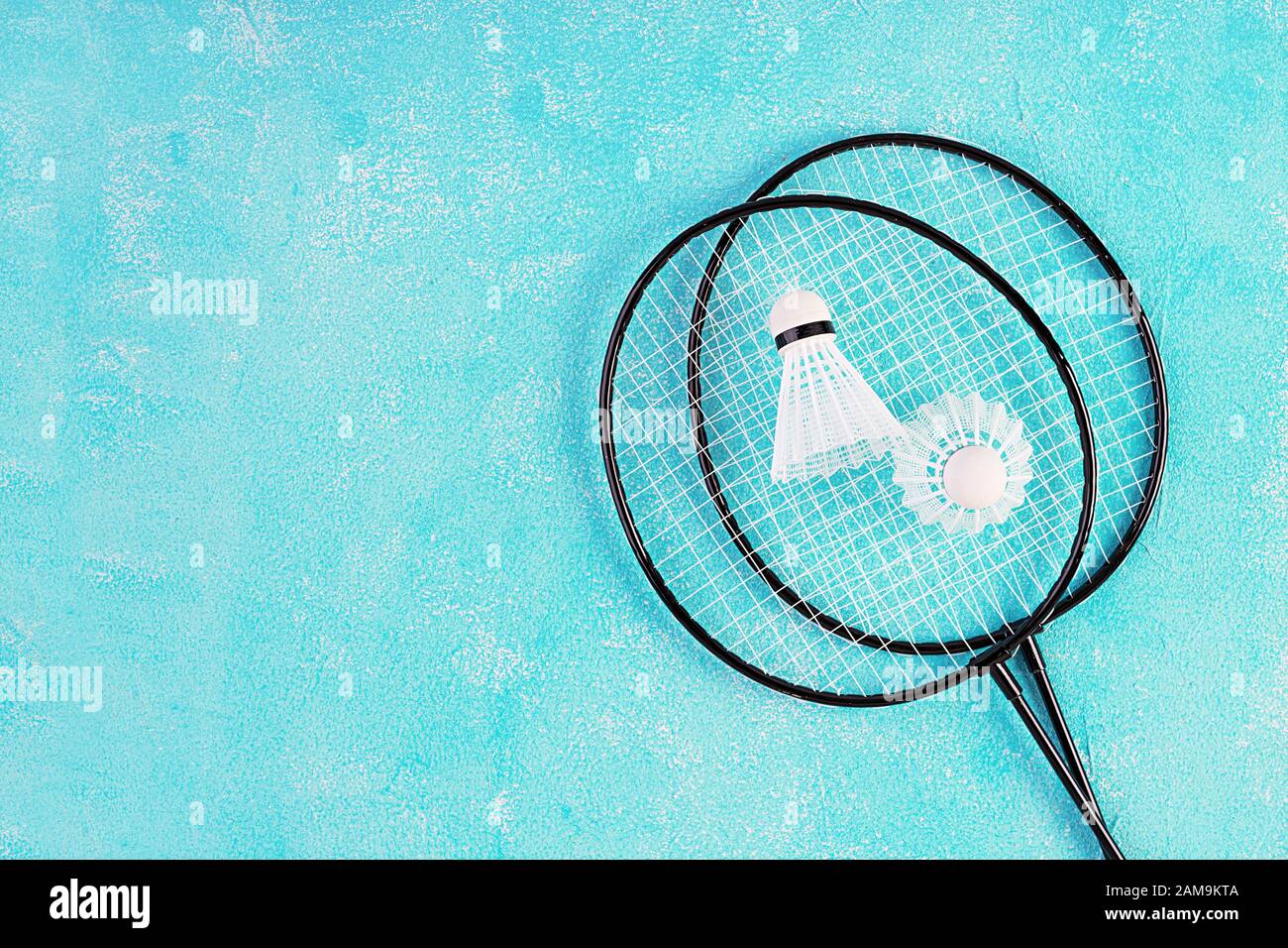 Shuttlecock and badminton rackets on a blue background. Top view Stock ...