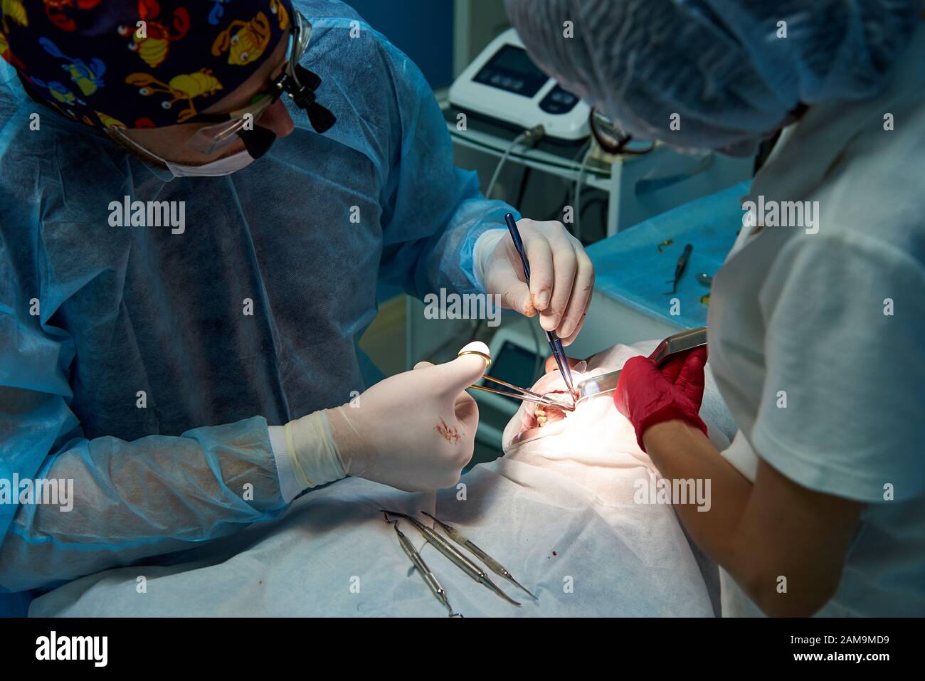 Surgery in the dental clinic.Doctor sews up a wound in the patient's ...