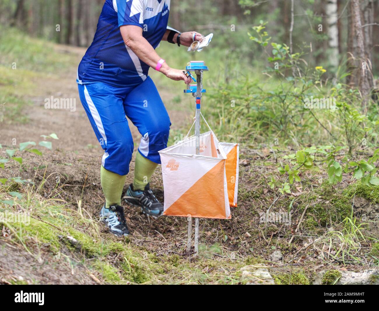 Rush sport people in forest checking chip with control point ...