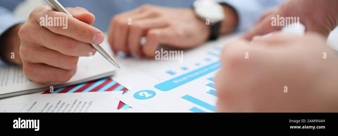 Group of people deliberate on problem with infographics Stock Photo - Alamy
