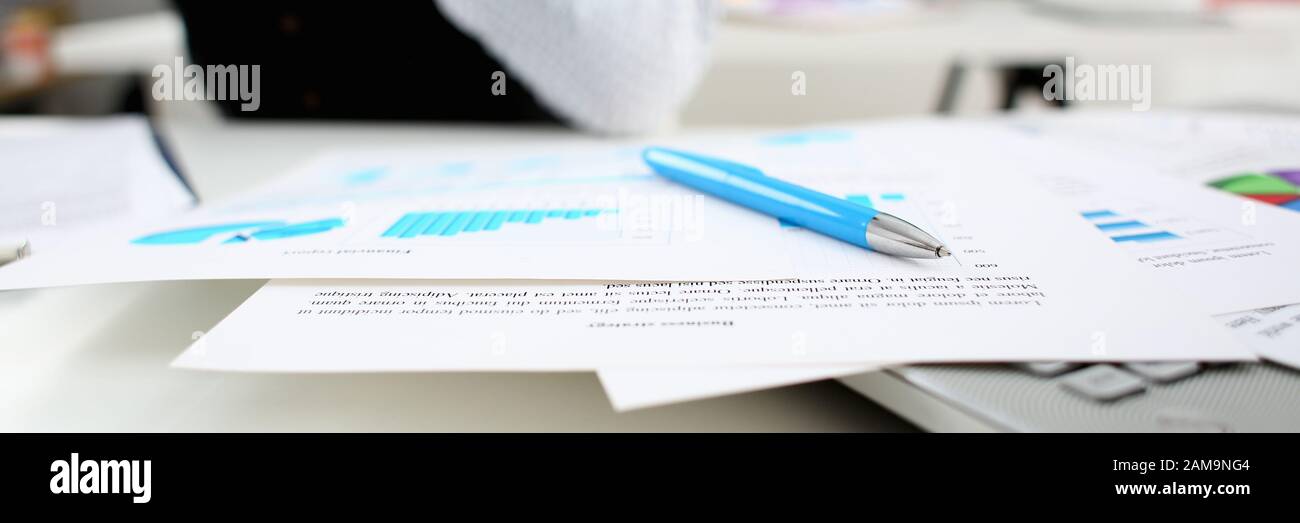 Silver pen lying on important paper at table Stock Photo - Alamy