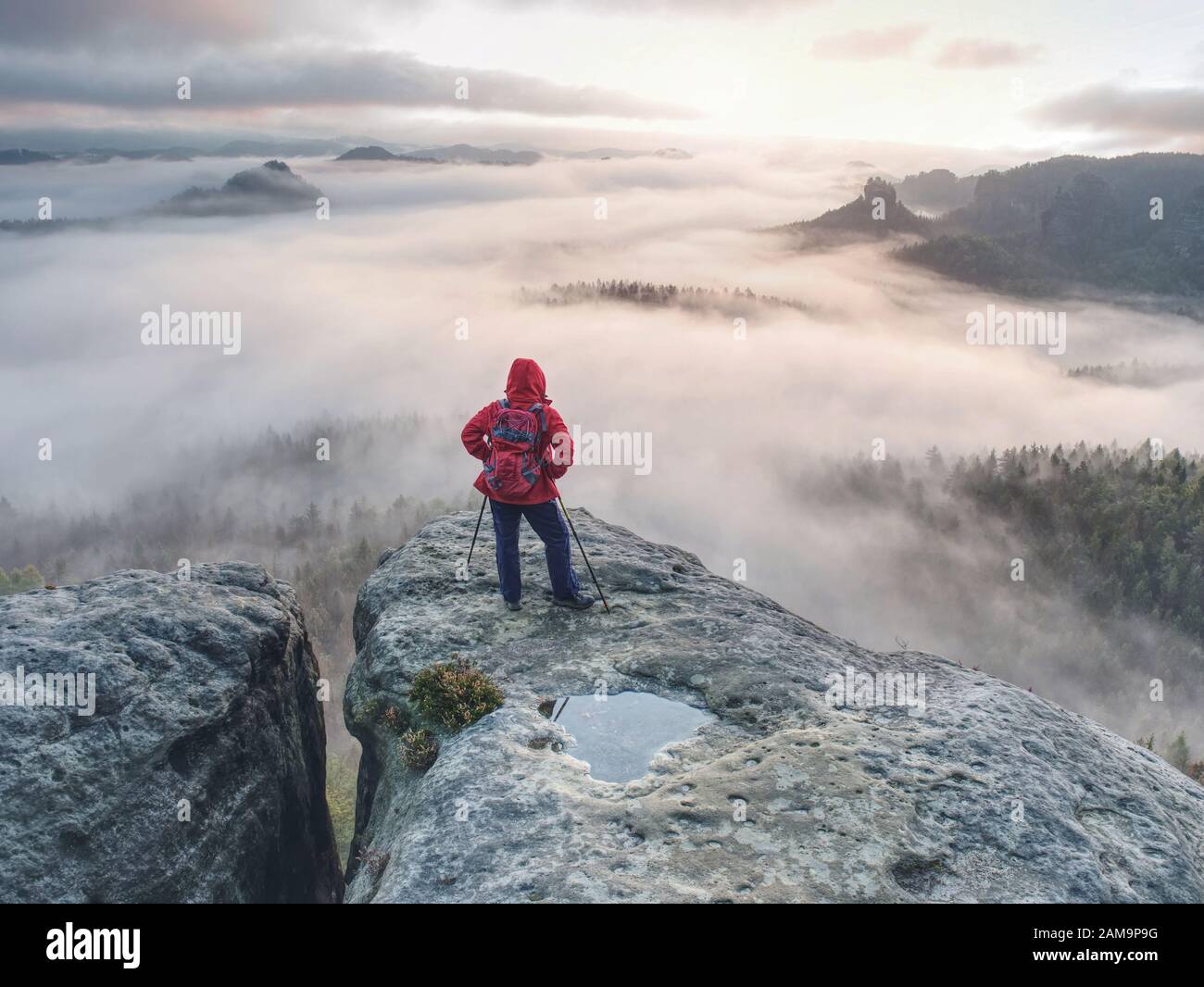 Extreme trail walker stop for relax above canyon full of heavy mist ...
