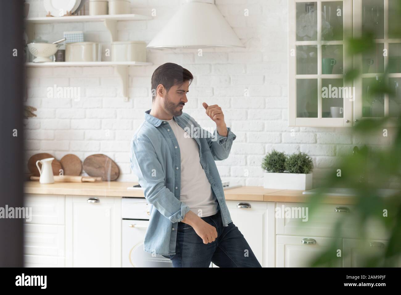 Happy handsome man dancing to music alone at kitchen Stock Photo - Alamy