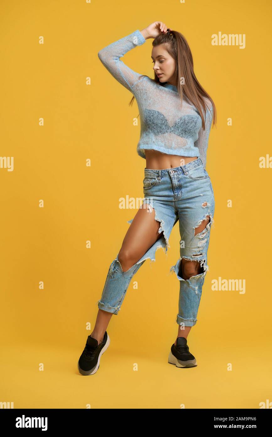 Pretty girl in full height putting arm on head, pulling toes. Woman ...