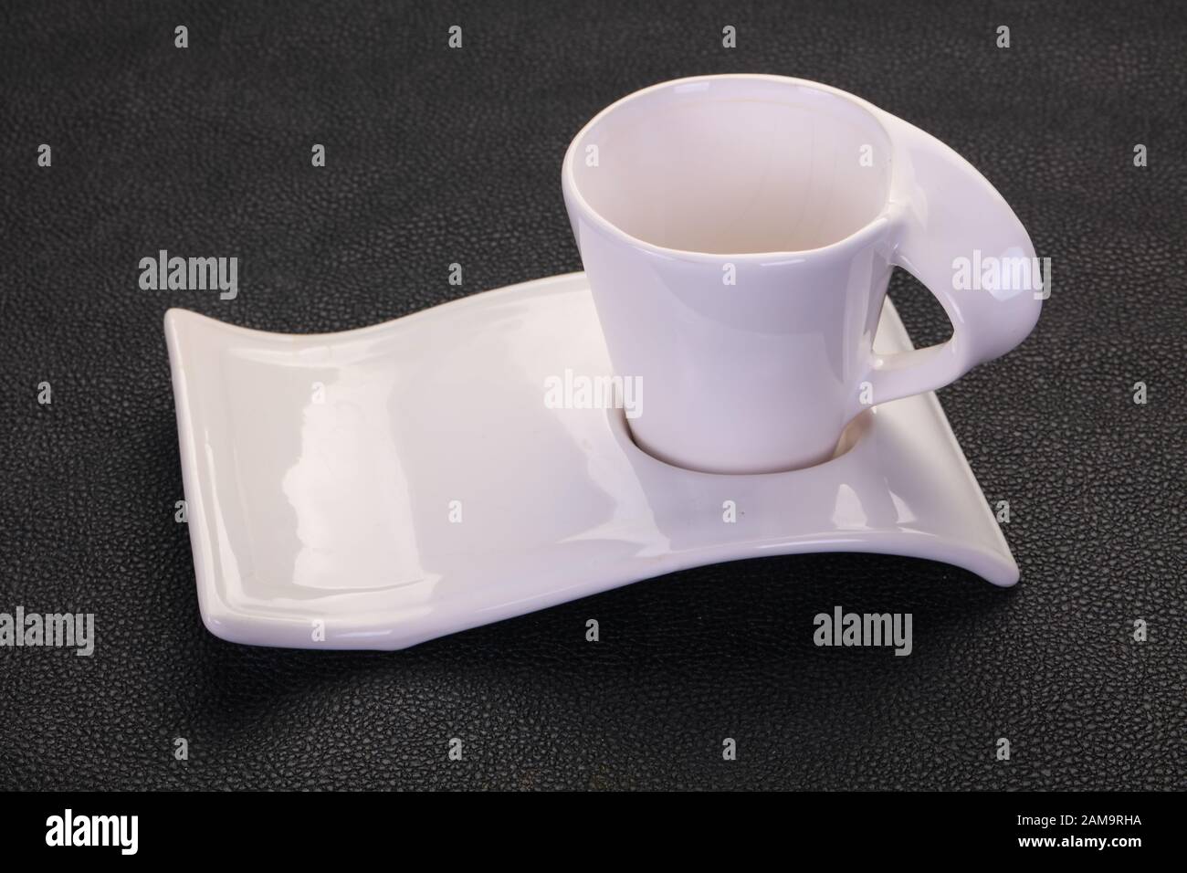 Empty ceramic cup over black background Stock Photo - Alamy