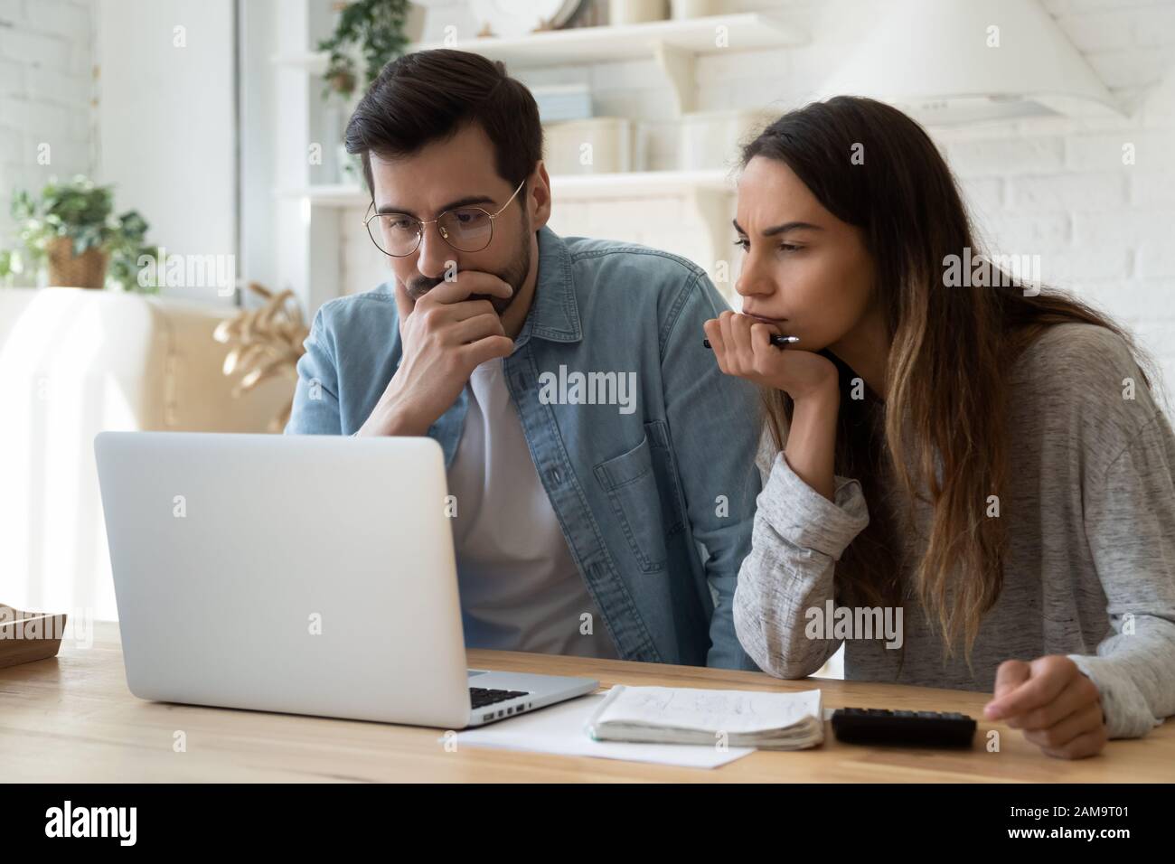 Head shot serious married couple looking at computer screen Stock Photo ...