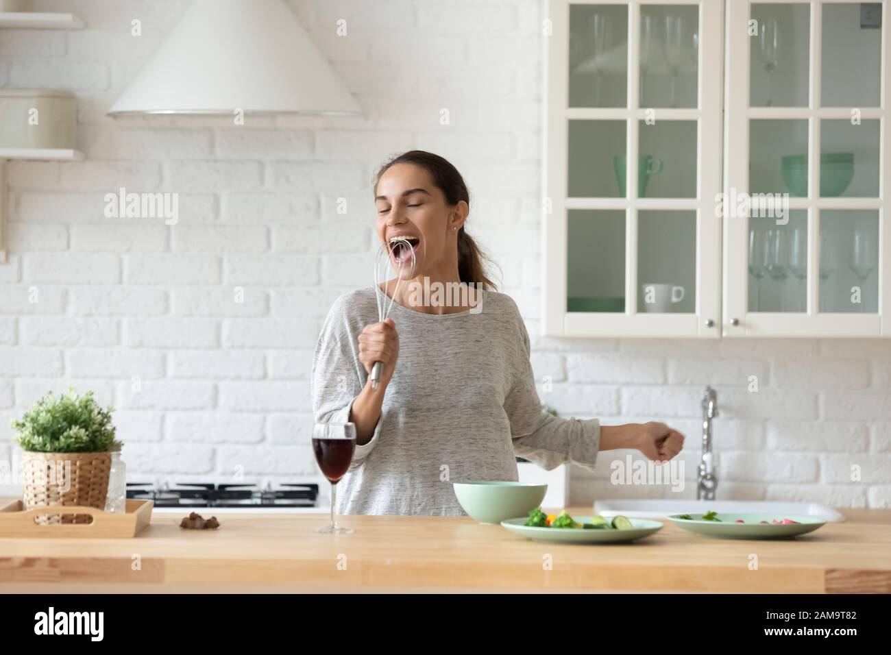 Happy lady having fun, cooking breakfast alone at home Stock Photo - Alamy