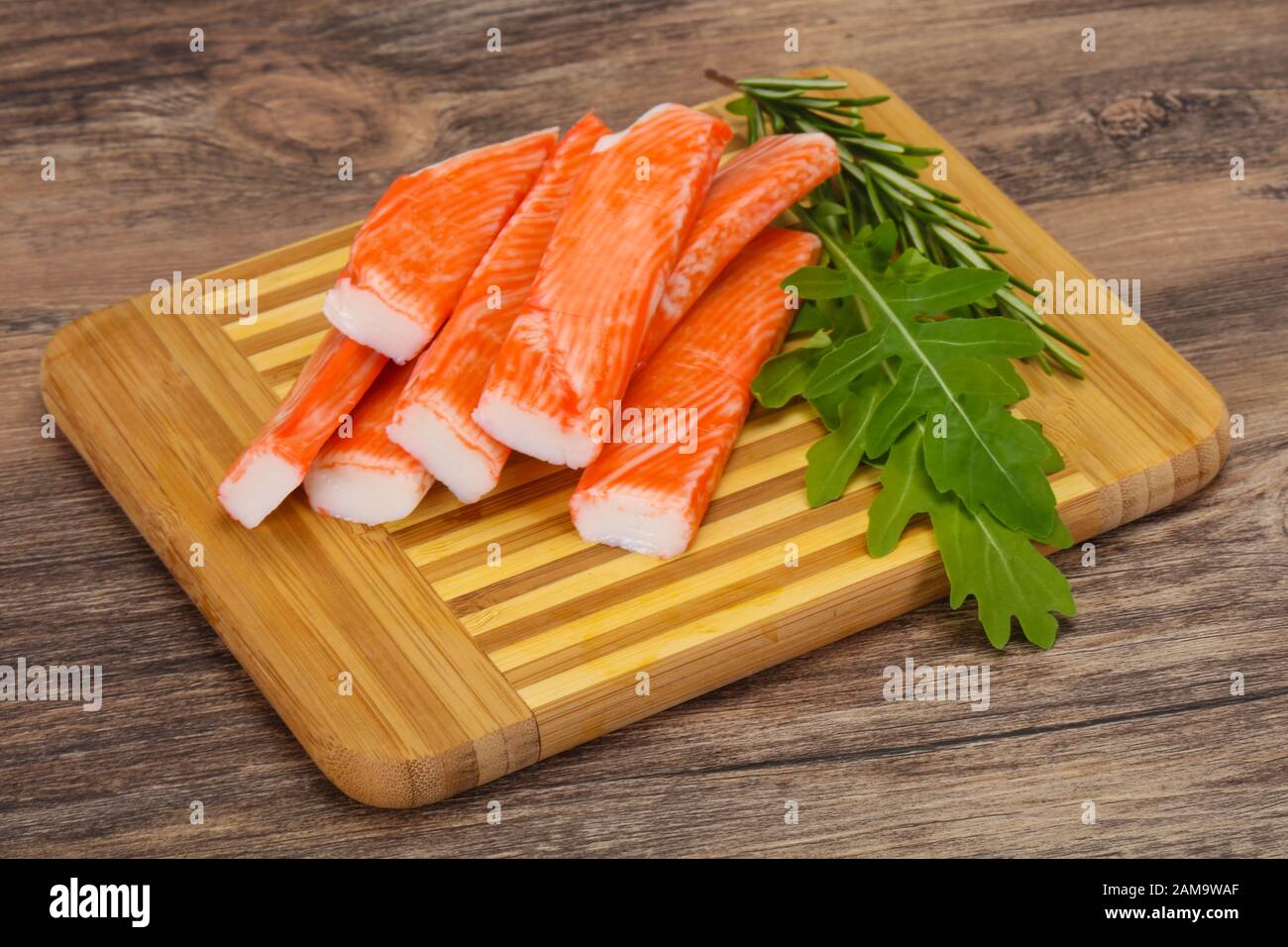 Crab stick surimi over wooden board Stock Photo - Alamy