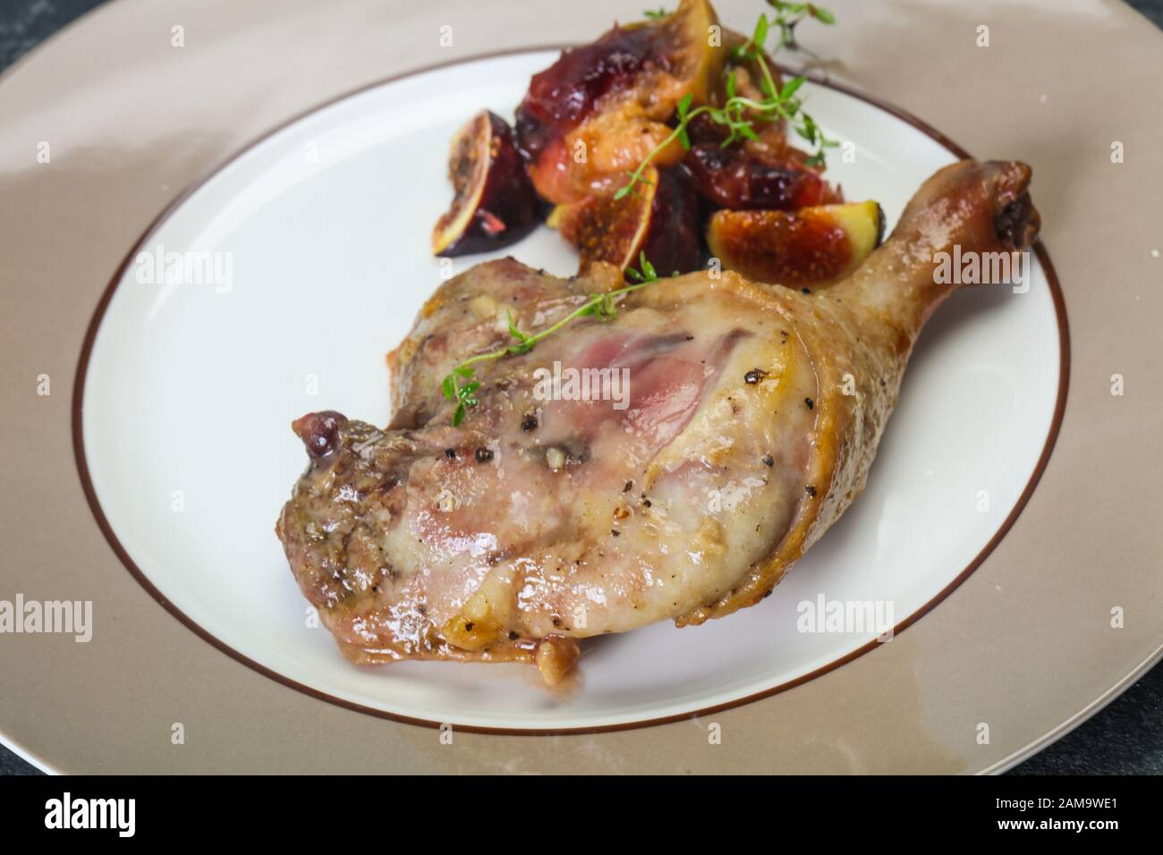 Roasted. duck. leg with plum, fig and apple Stock Photo - Alamy