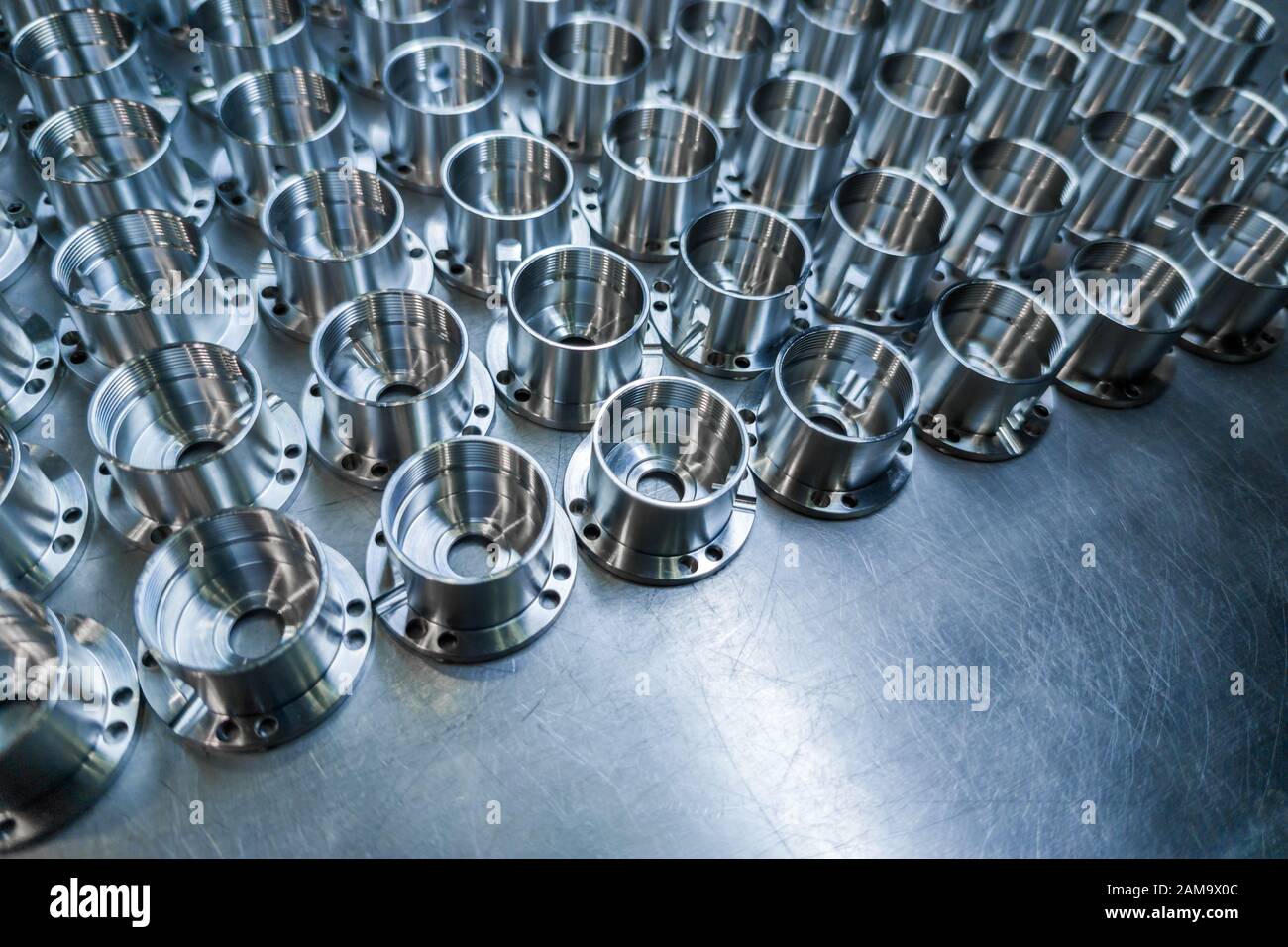 Shiny metal parts after cnc turning, drilling and machining on steel ...