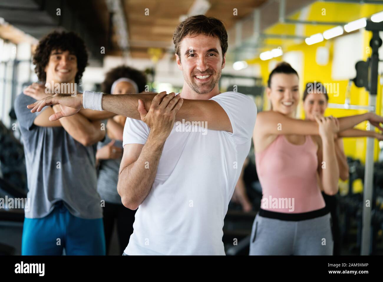 Group of happy multiracial friends exercising together in gym Stock ...
