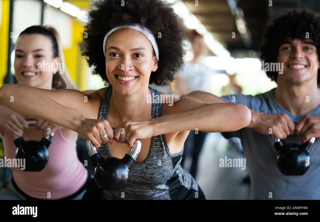 Group of happy multiracial friends exercising together in gym Stock ...