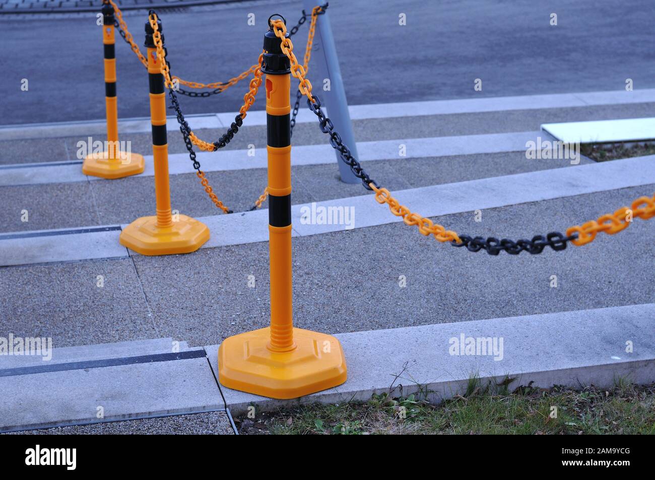 barrier of plastic poles and chain keeping safe pedestrians on a ...