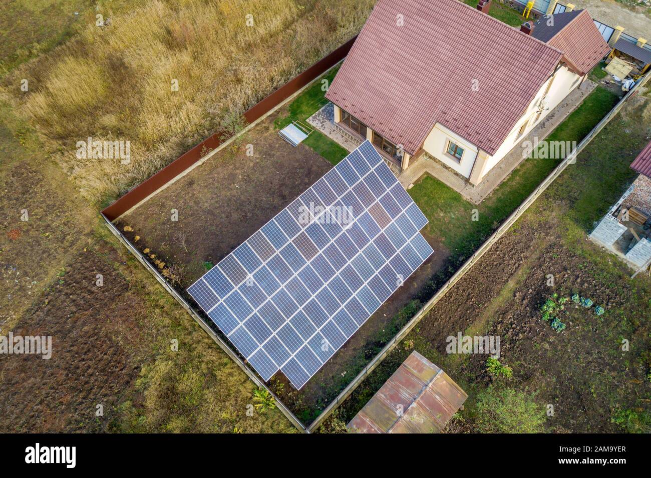 Aerial view of big blue solar panel installed on ground structure near ...