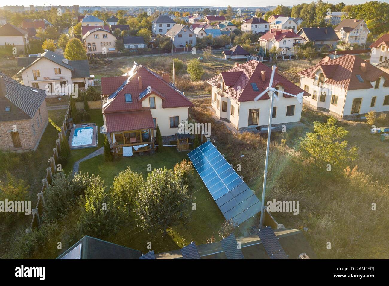 Aerial view of a residential private house with solar panels on roof ...