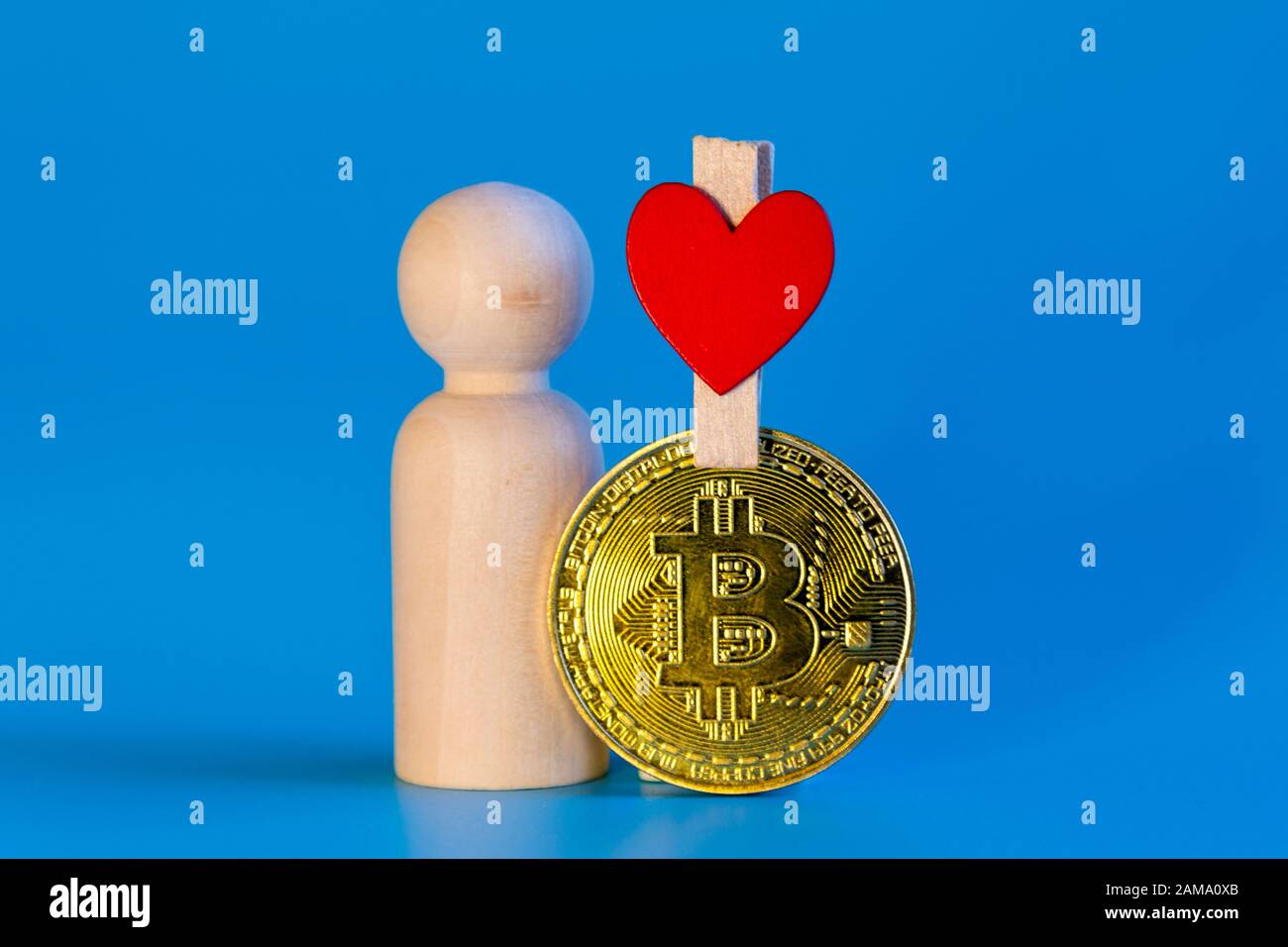 Human figurine, bitcoin coin and heart on a blue background. love for ...