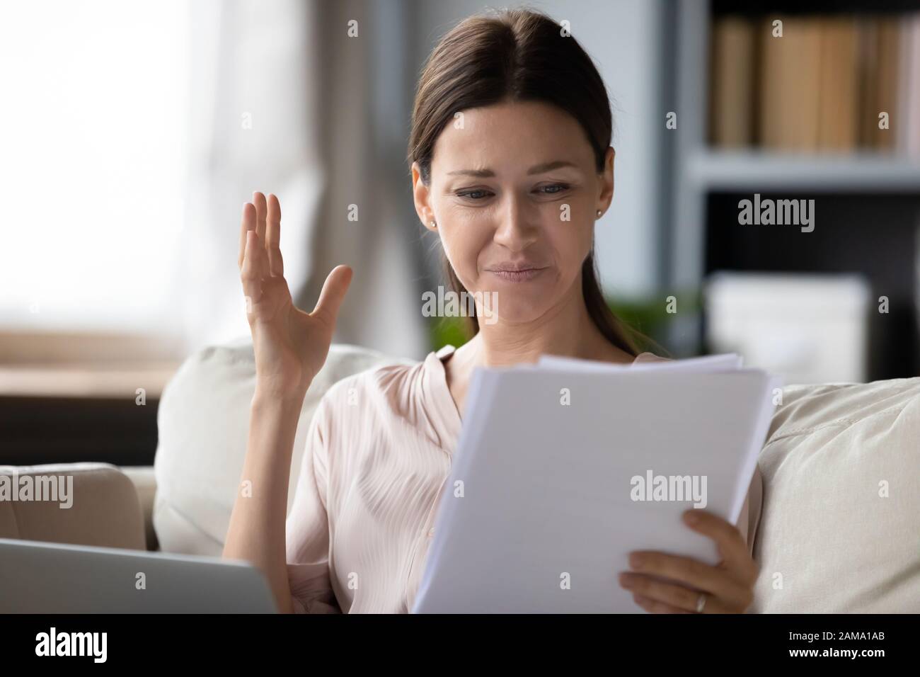 Stressed young woman get unpleasant postal paperwork letter Stock Photo ...