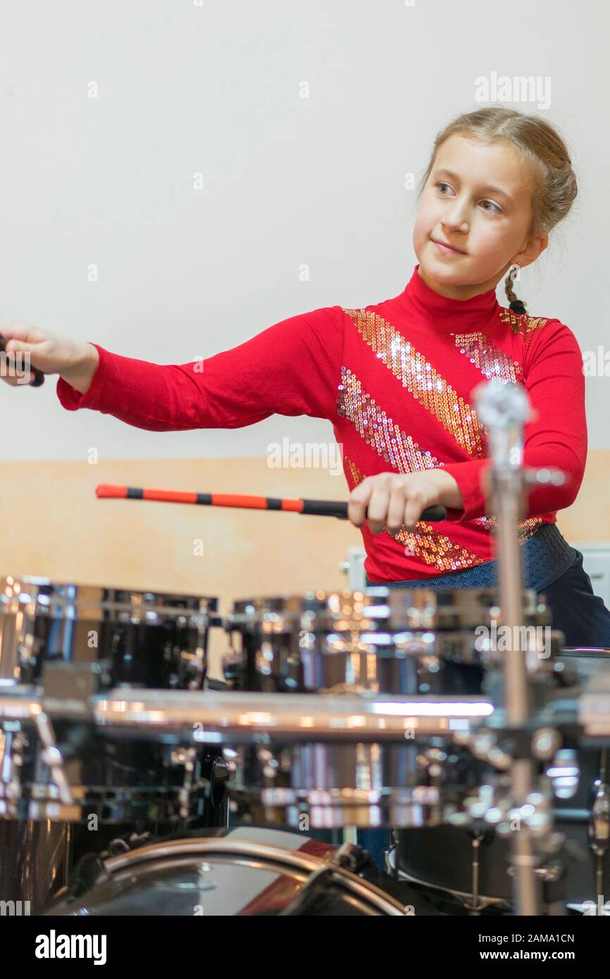 Teen girl playing the drums. Teen girls are having fun playing drum ...