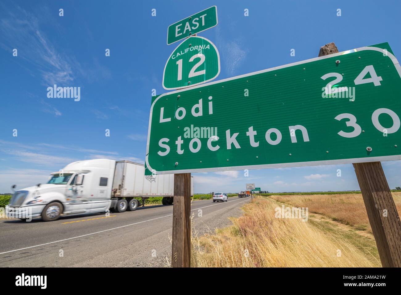 View of signpost and freightliner on Highway 12, San Francisco ...