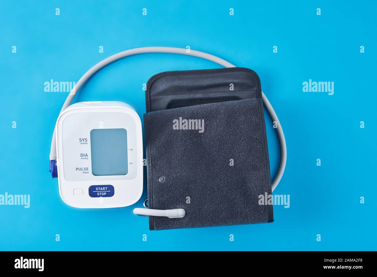 Digital blood pressure monitor on blue background, closeup. Helathcare ...