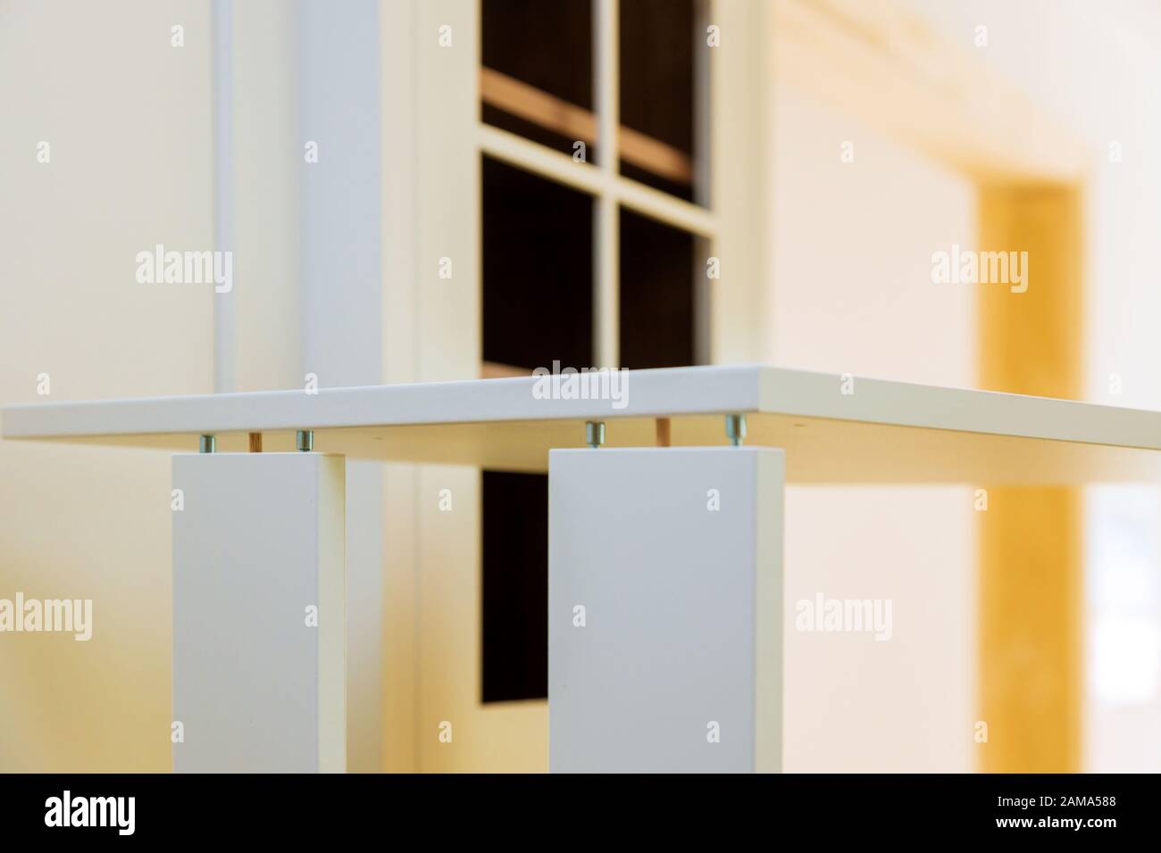 Assembly new white furniture at his home Stock Photo - Alamy