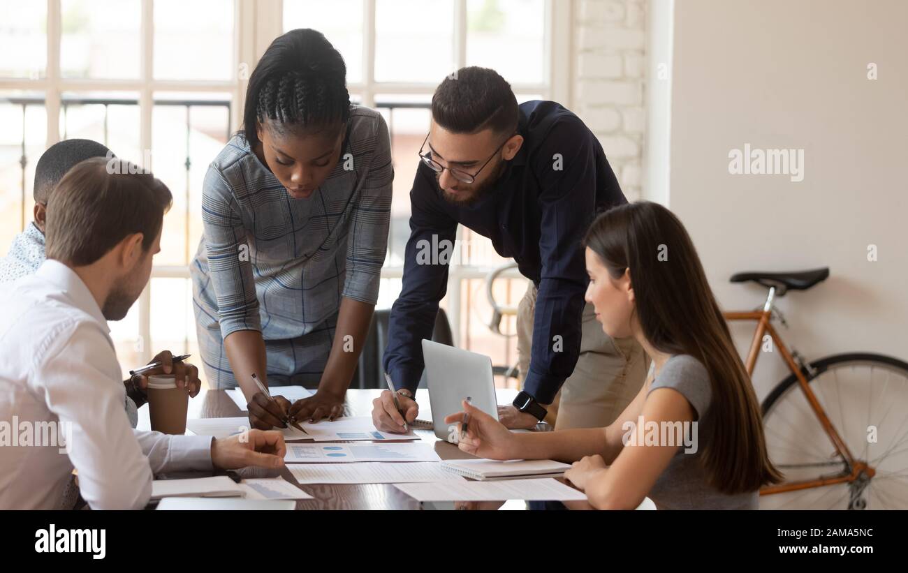 Focused diverse male female colleagues hi-res stock photography and ...