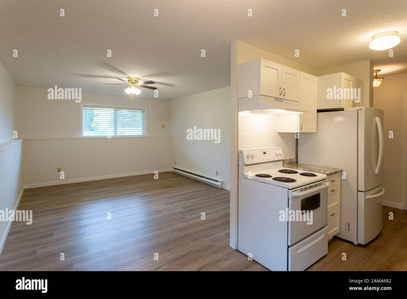 Interior of empty renovated apartment condo rental unit with white ...