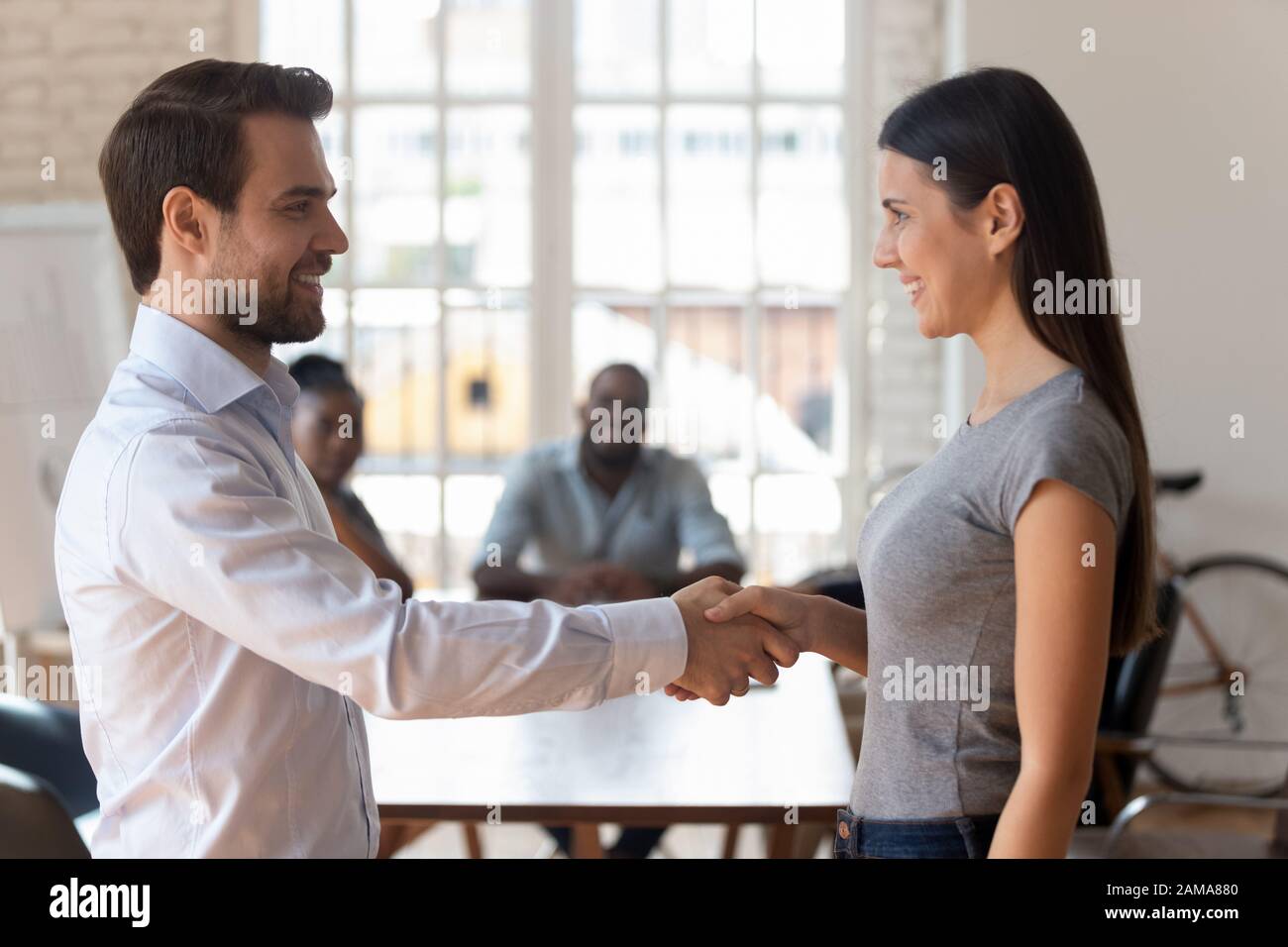 Male boss handshake female employee greeting with promotion Stock Photo ...
