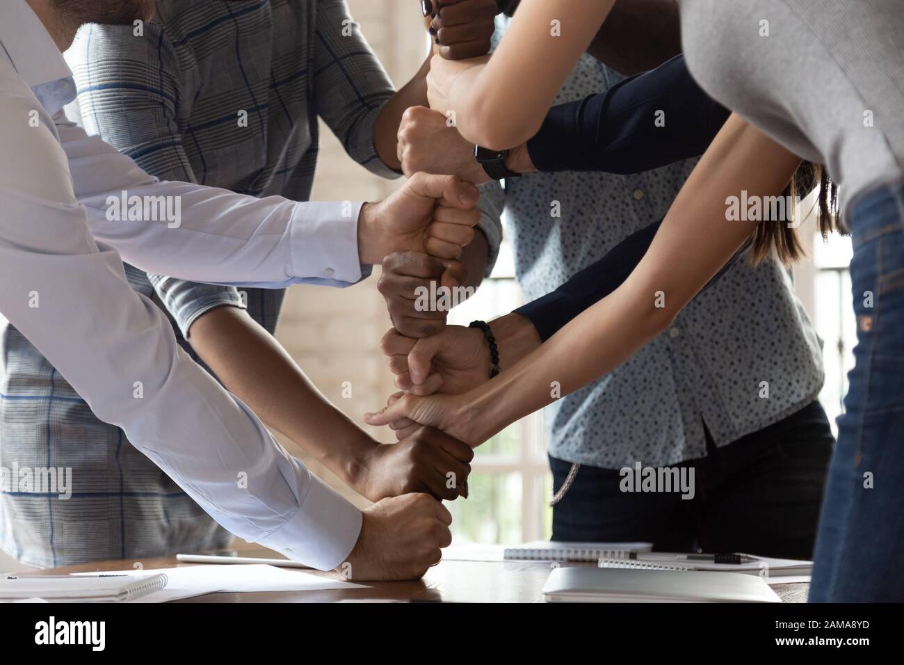 Diverse employees engaged in teambuilding activity at meeting Stock ...