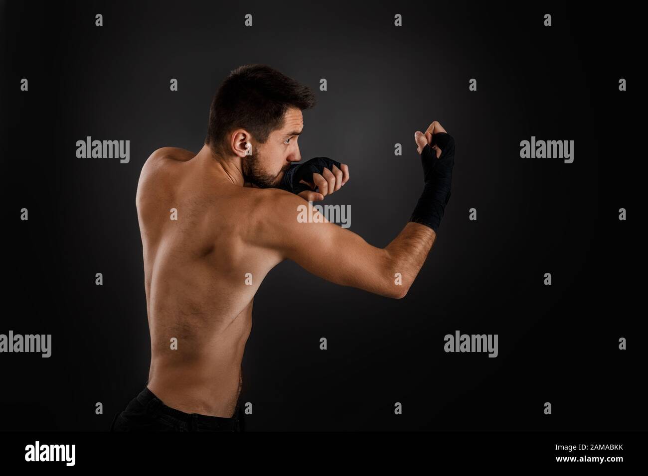 Sportsman boxer throwing a fierce and powerful punch. muscular man on ...