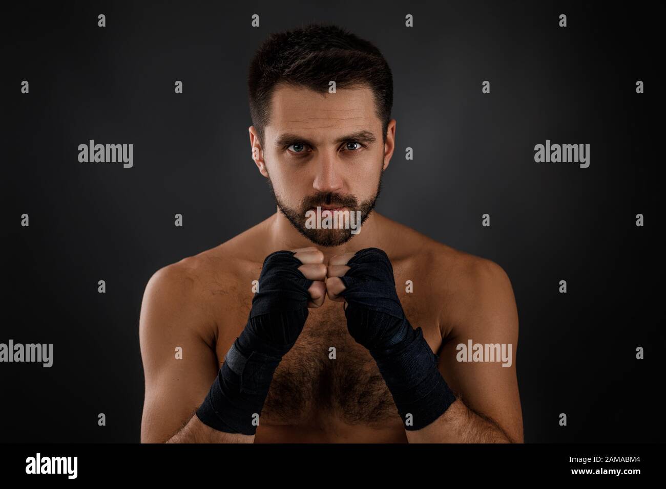 Muscular boxing man ready to fight on black background Stock Photo - Alamy