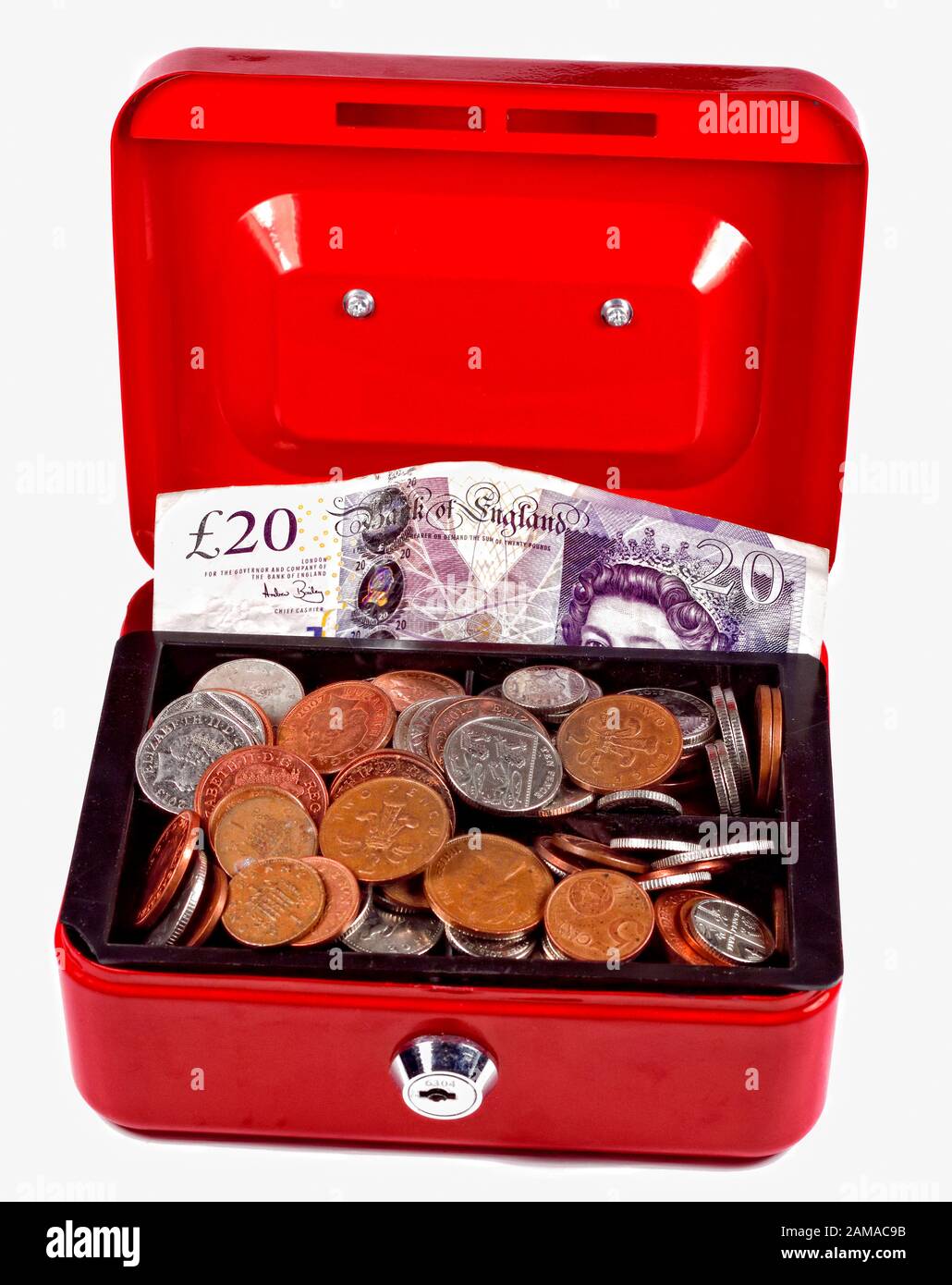 Red cash tin with coin change and a twenty pound note on a white ...