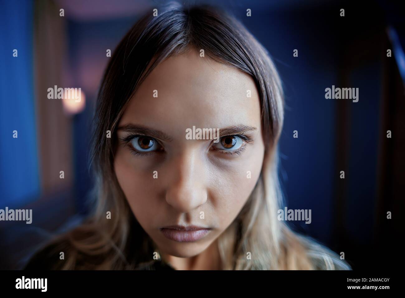 Evil look of a young crazy blonde. Close up face of annoyed caucasian ...