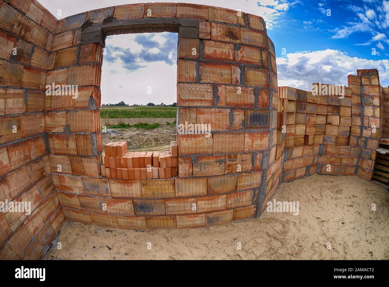 Construction of red bricks house in rural area Stock Photo - Alamy