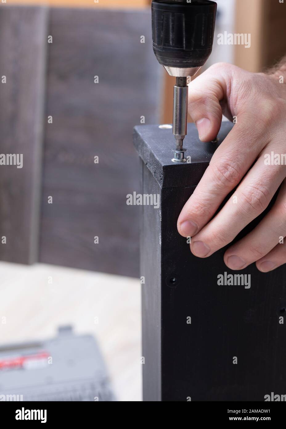 closeup man worker in work clothes working with screwdriver in his ...