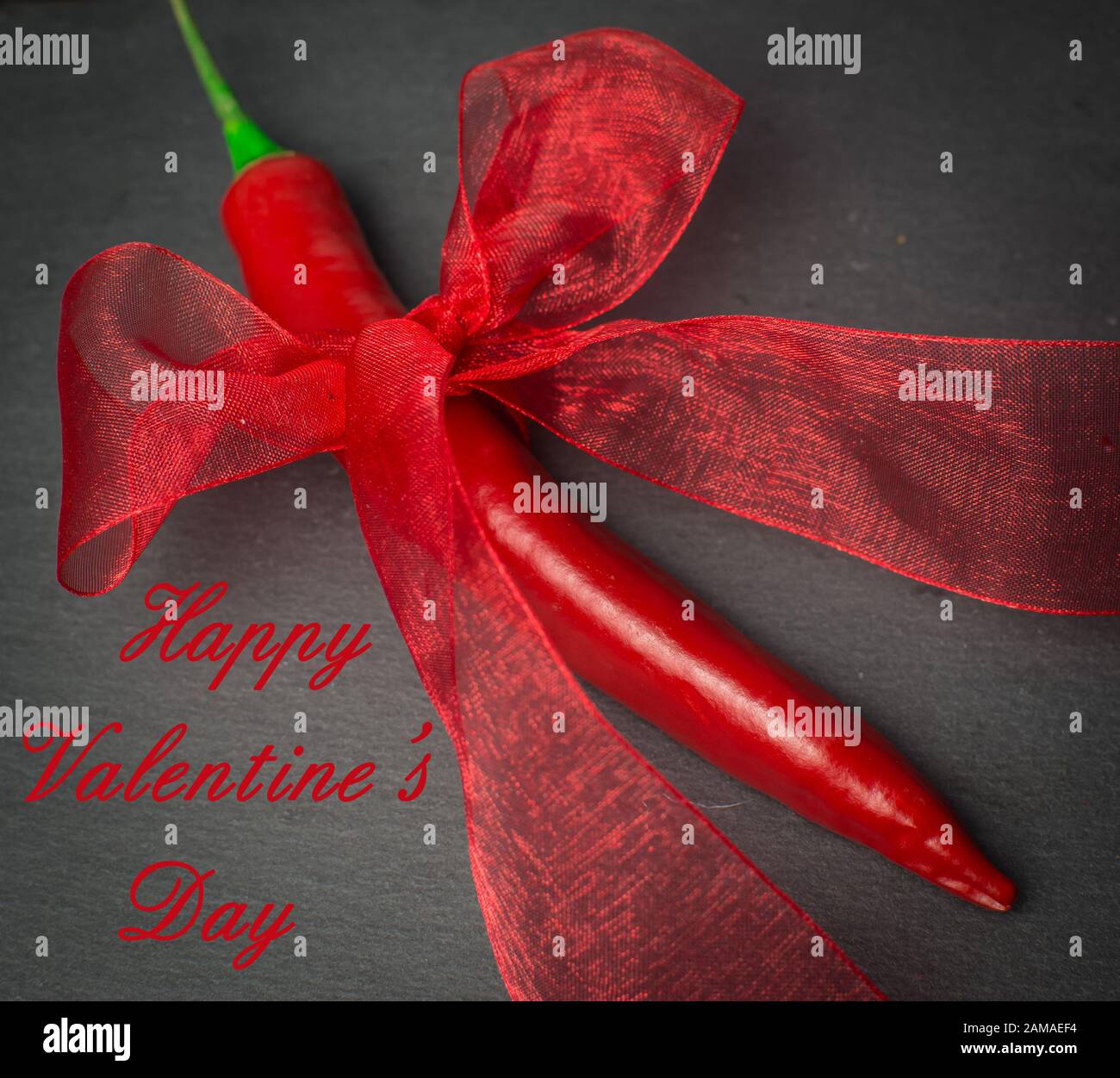 black background with red chilli and text "happy valentine day Stock ...