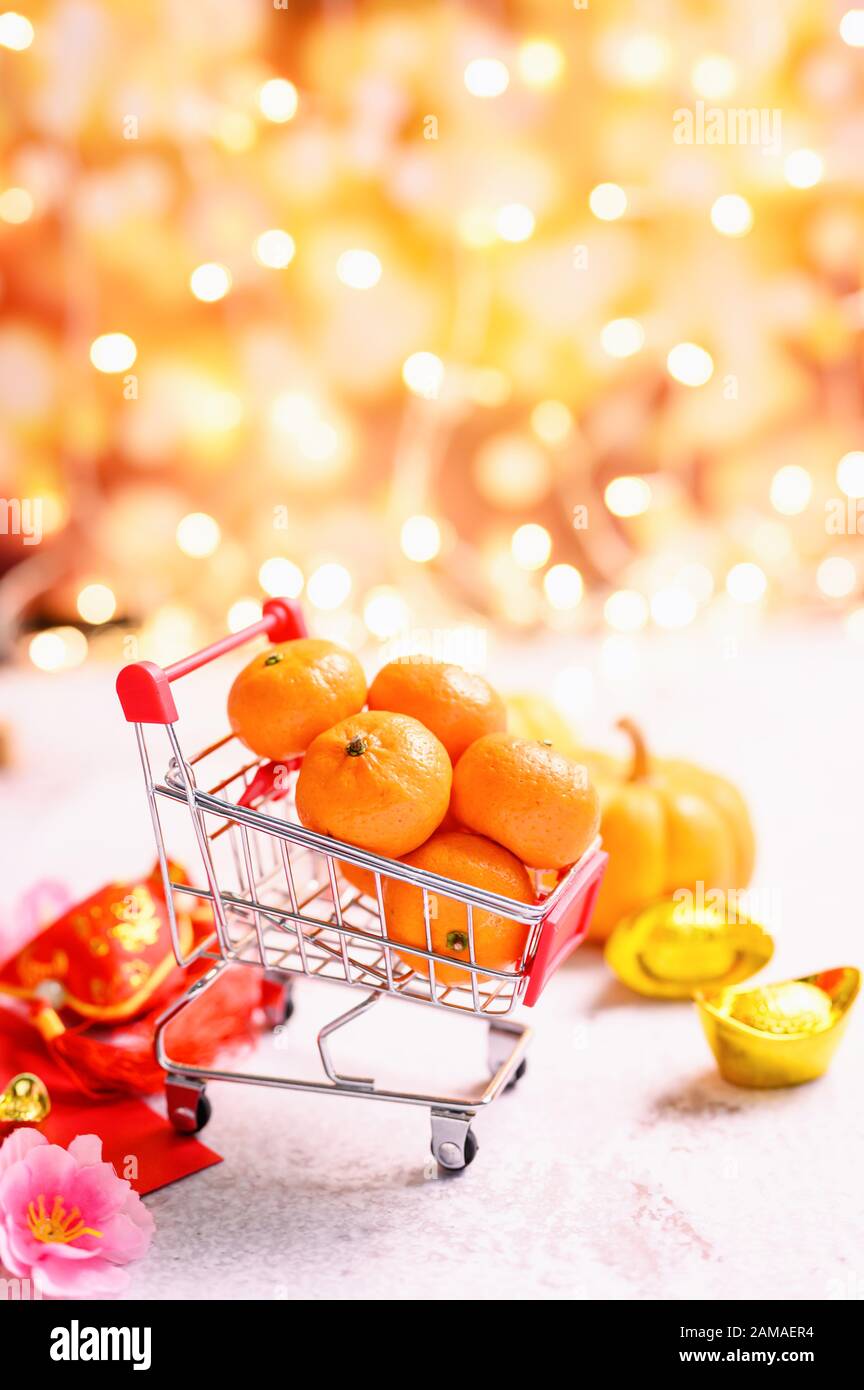 Chinese New Year, Shopping car with orange and China gold ingots ...