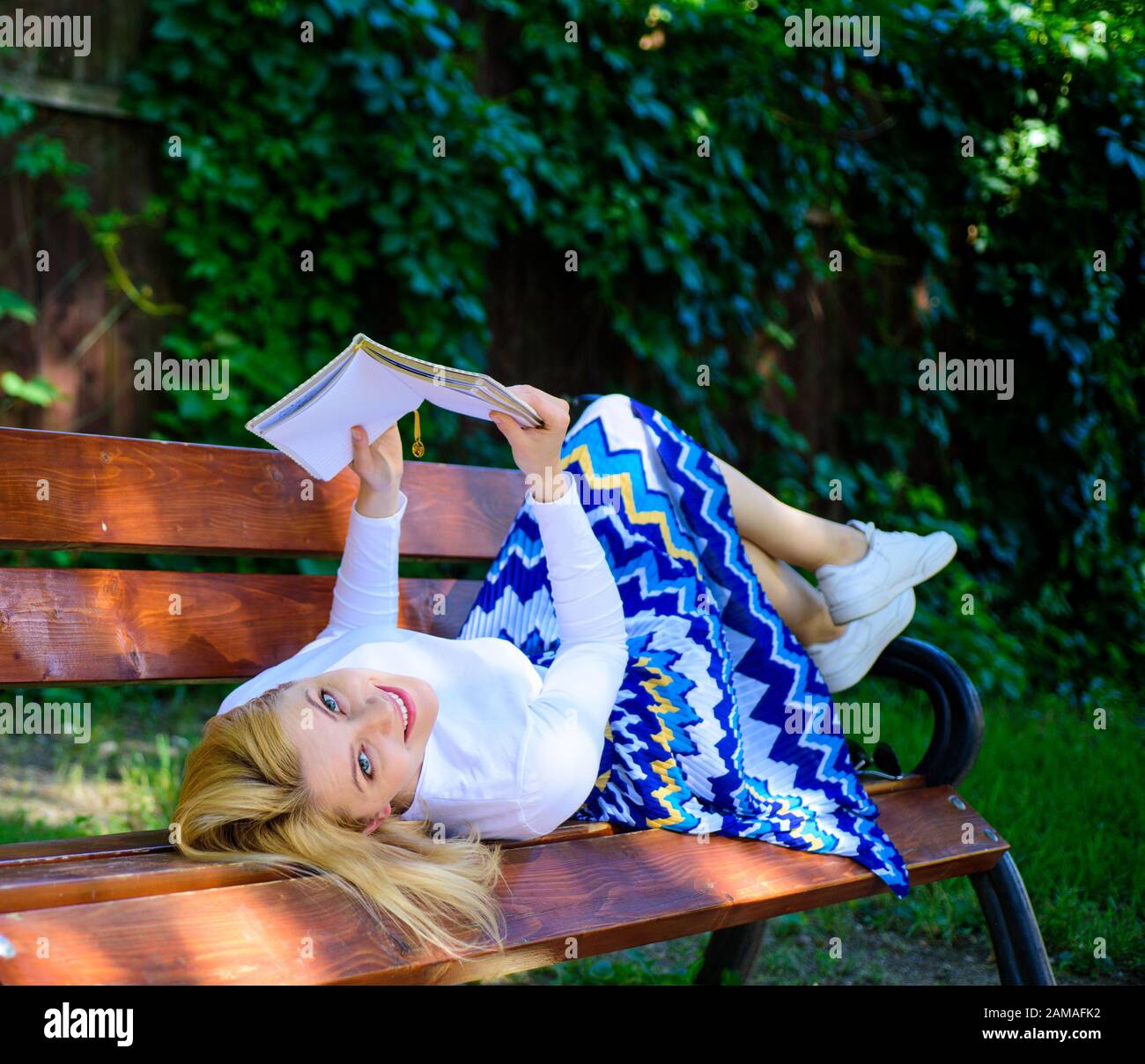 Smart and pretty. Smart lady relaxing. Girl lay bench park relaxing ...