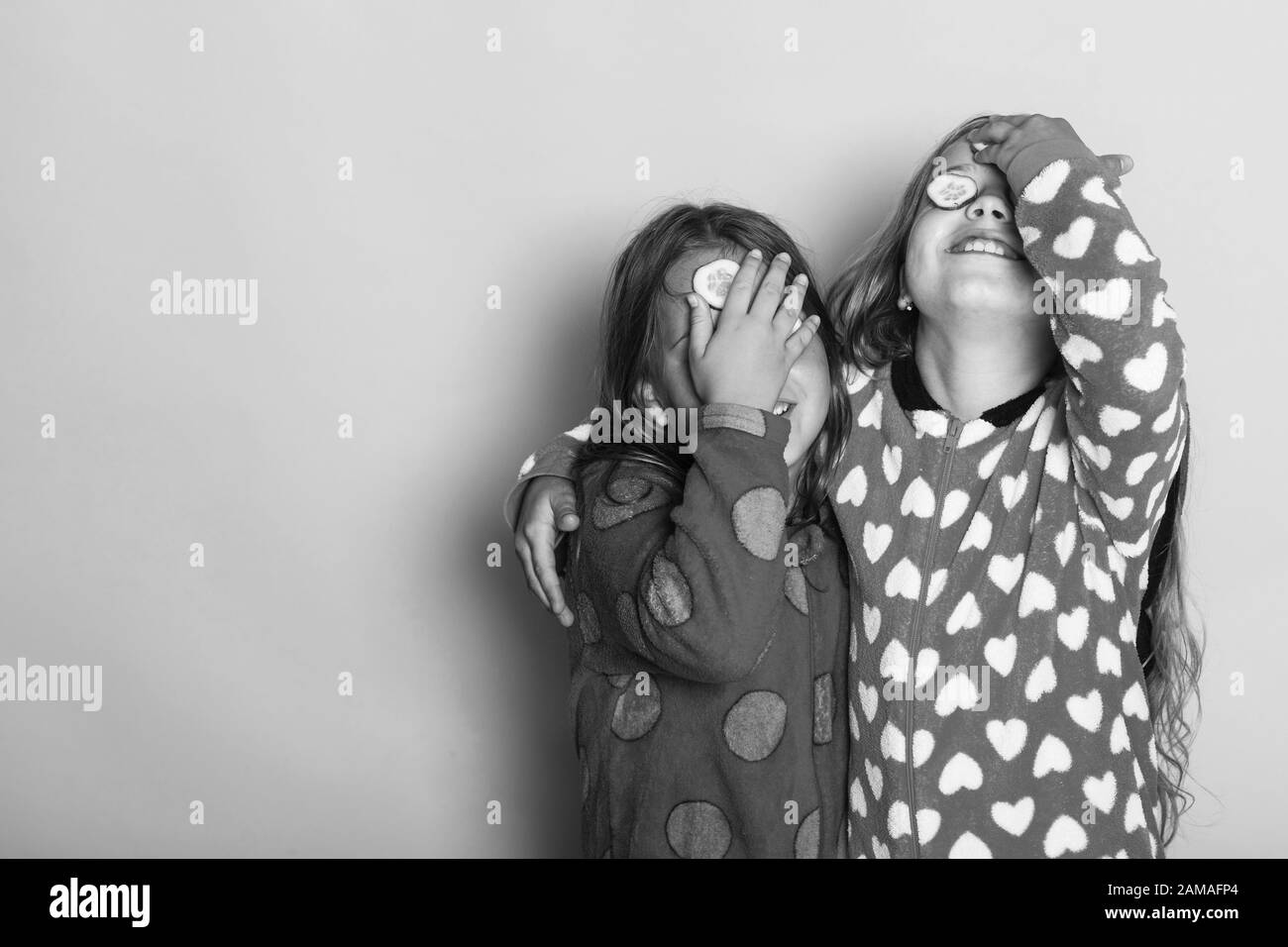 Kids pose on pink background, copy space. Girls in colorful polka ...