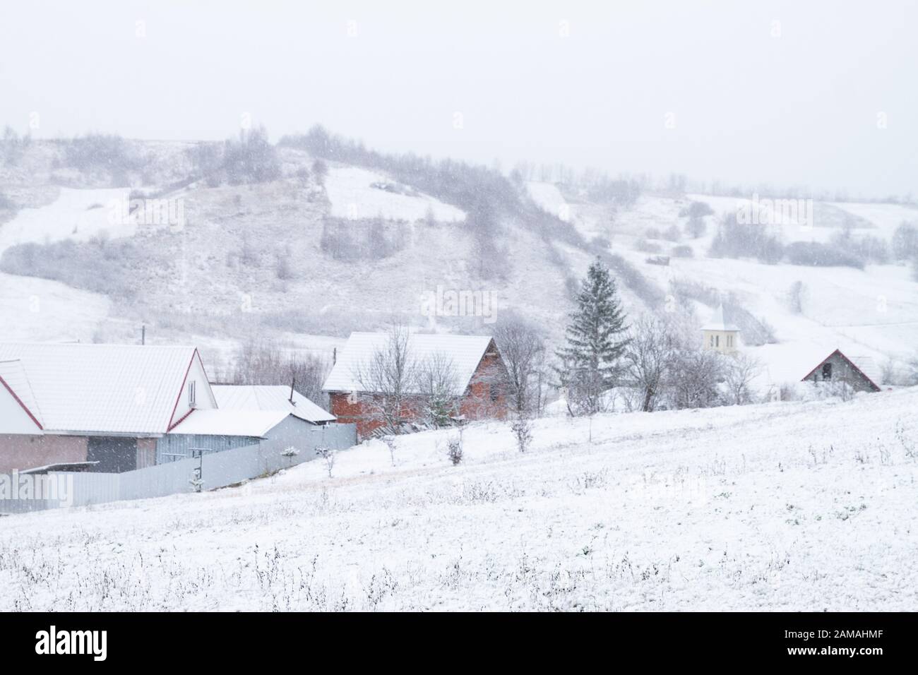 Image of white winter landscape during snowfall in rural setting in ...