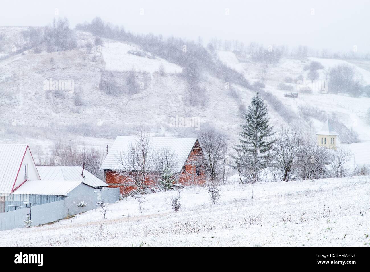 Image of white winter landscape during snowfall in rural setting in ...