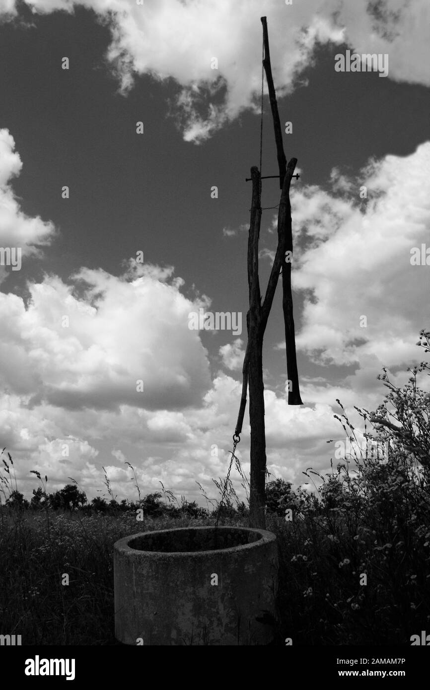 Rural landscape village against cloudy Black and White Stock Photos ...