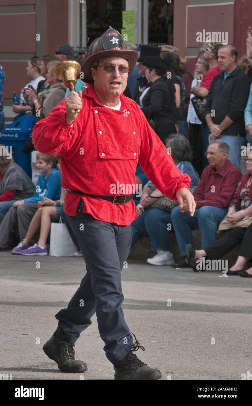 Fireman in traditional costume, ringing a bell, at Dickens on The ...
