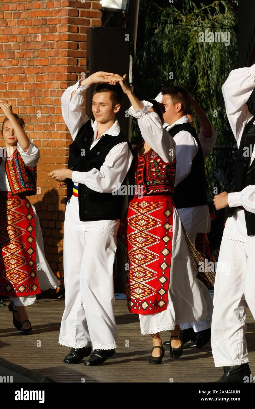 Professional dancers of the Banatul Folklore Ensemble hold hands in a ...