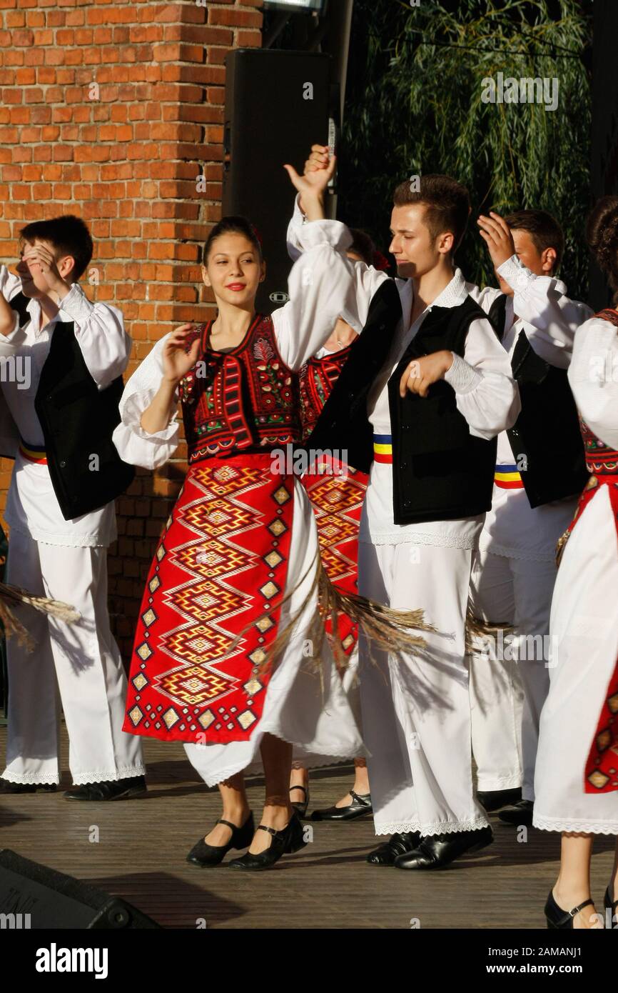 Professional dancers of the Banatul Folklore Ensemble hold hands in a ...