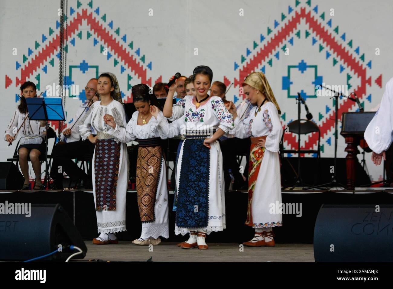 Professional dancers of the Banatul Folklore Ensemble hold hands in a ...