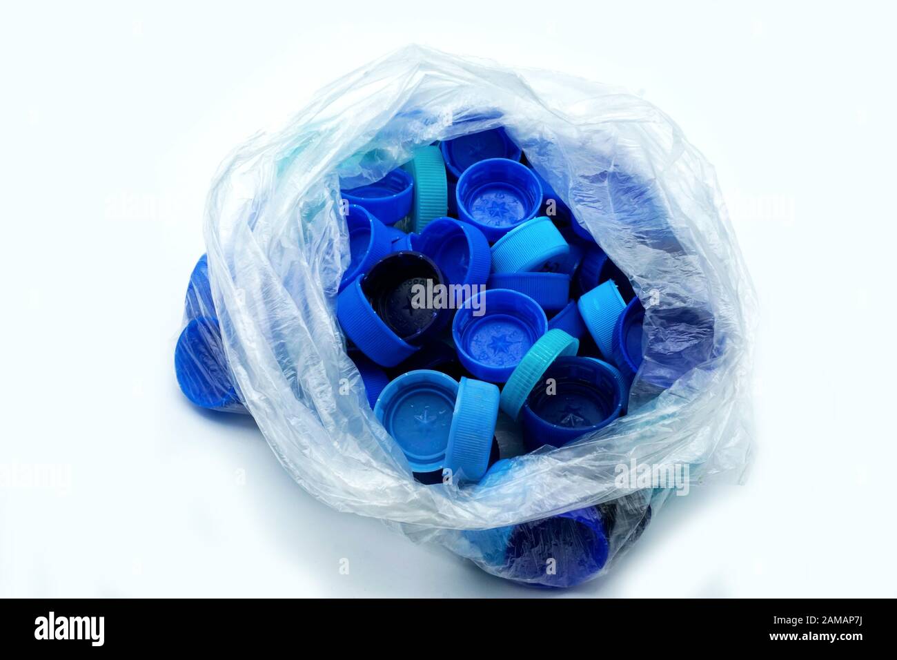 Blue plastic bottle caps sorted by colors in transparent single use ...