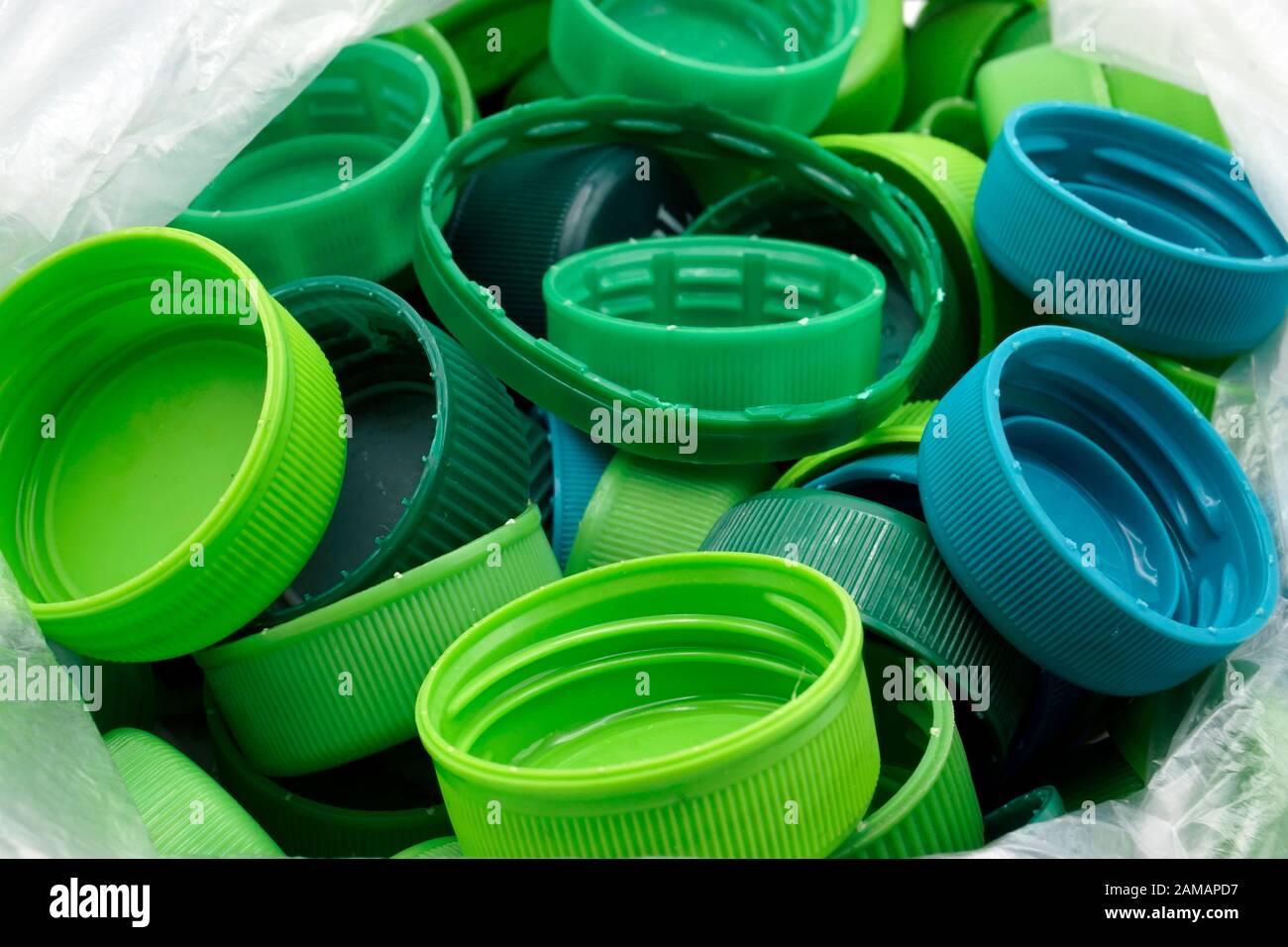 Green plastic bottle caps sorted by colors in transparent single use ...