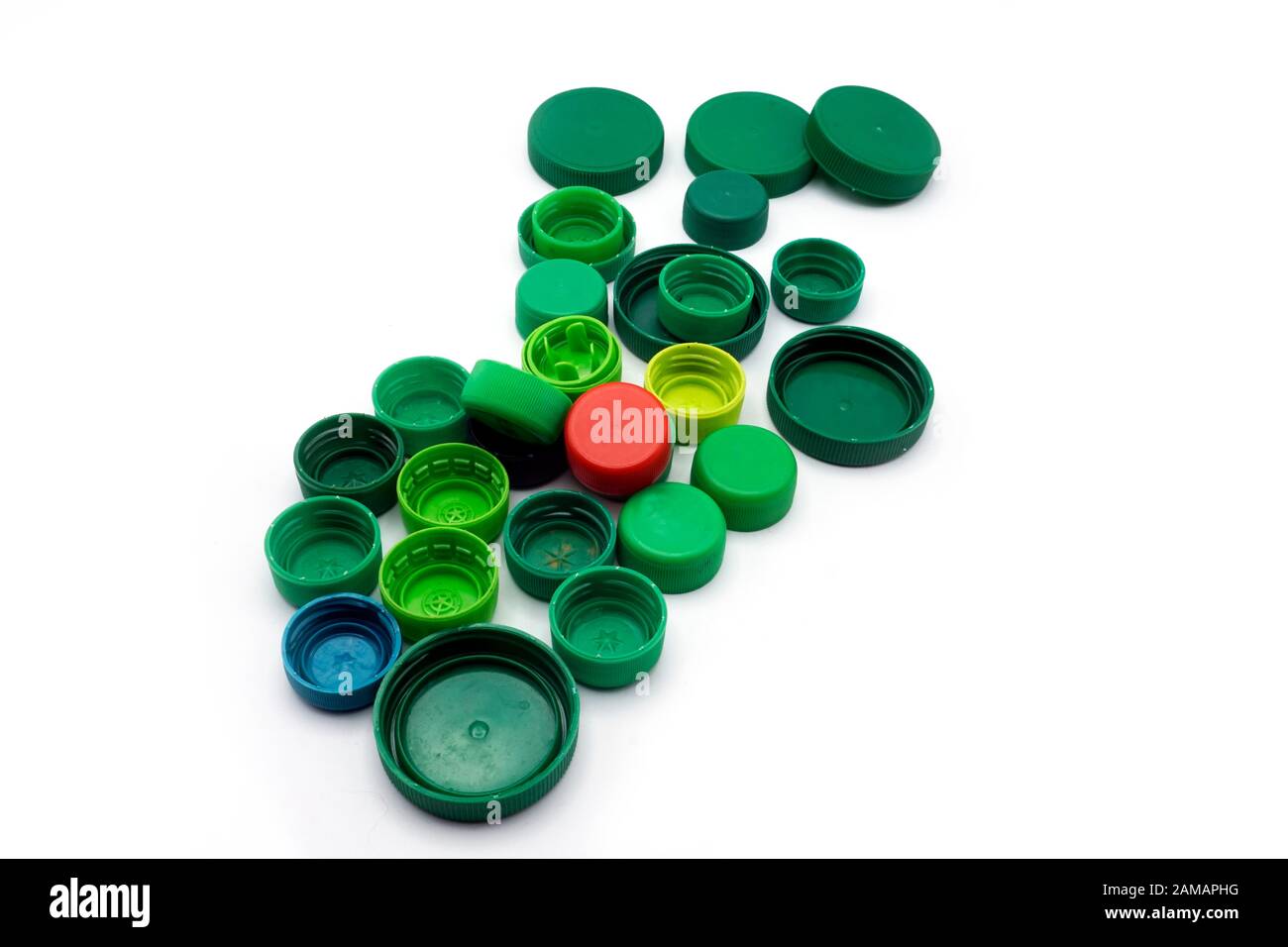 Green plastic bottle caps isolated on white background. PP and PET ...