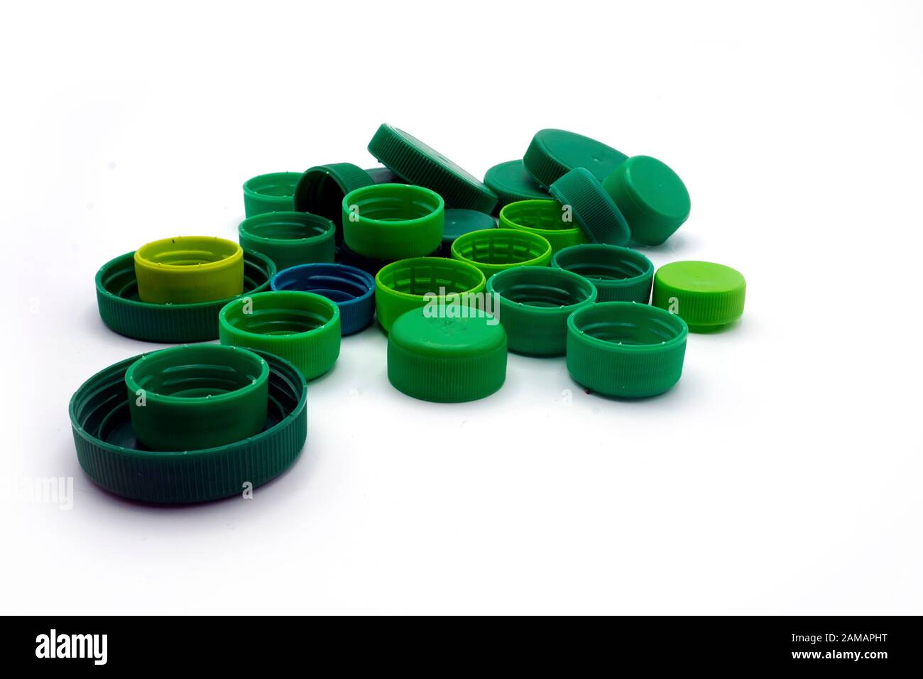 Green plastic bottle caps isolated on white background. PP and PET ...